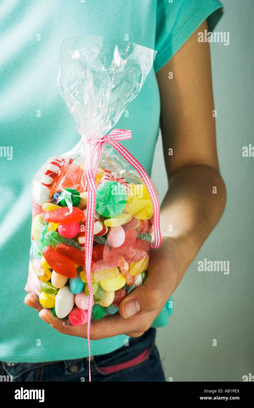 Hand holding bag of sweets hi-res stock photography and images - Alamy