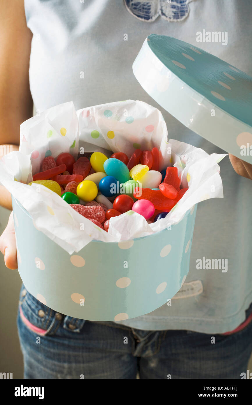 Hands holding a box of assorted sweets FoodCollection Stock Photo - Alamy