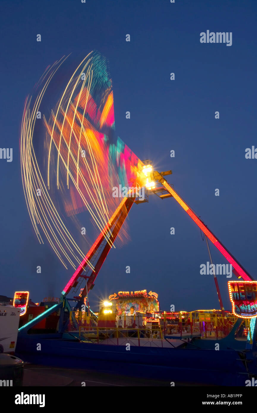 vertical fairground ride in motion over fun park fair ground Stock ...