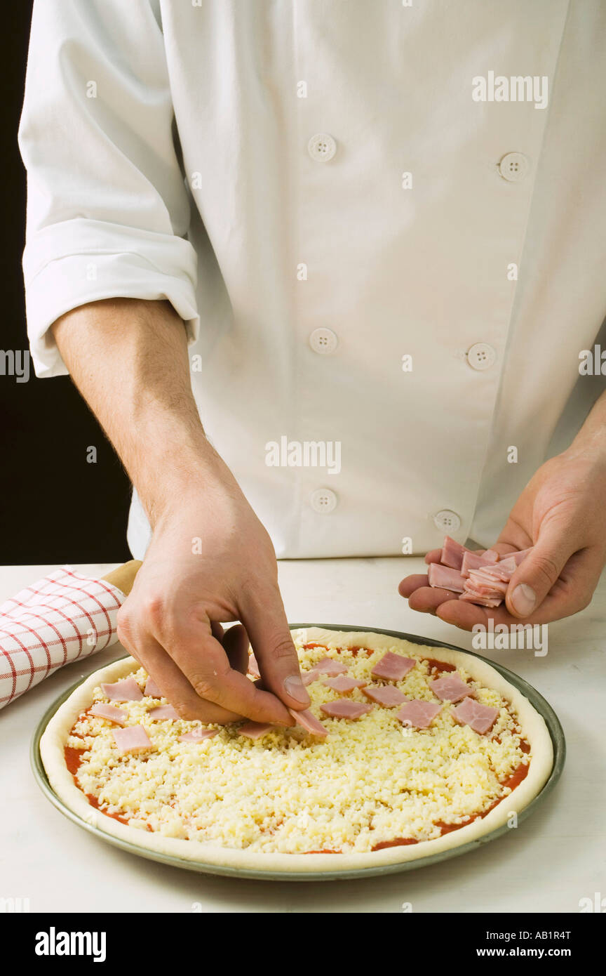 Topping a pizza with ham FoodCollection Stock Photo - Alamy