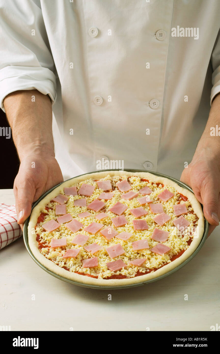 Topping a pizza with ham FoodCollection Stock Photo - Alamy