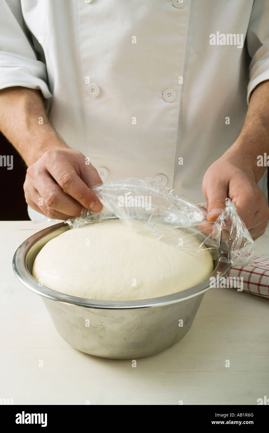 Leaving pizza dough to rest in a bowl removing clingfilm FoodCollection ...