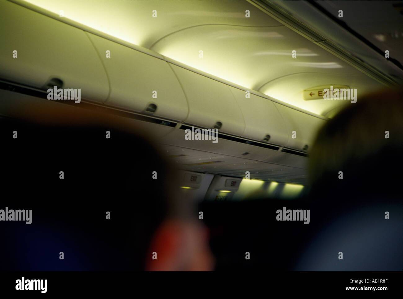 Exit sign in airplane Stock Photo - Alamy