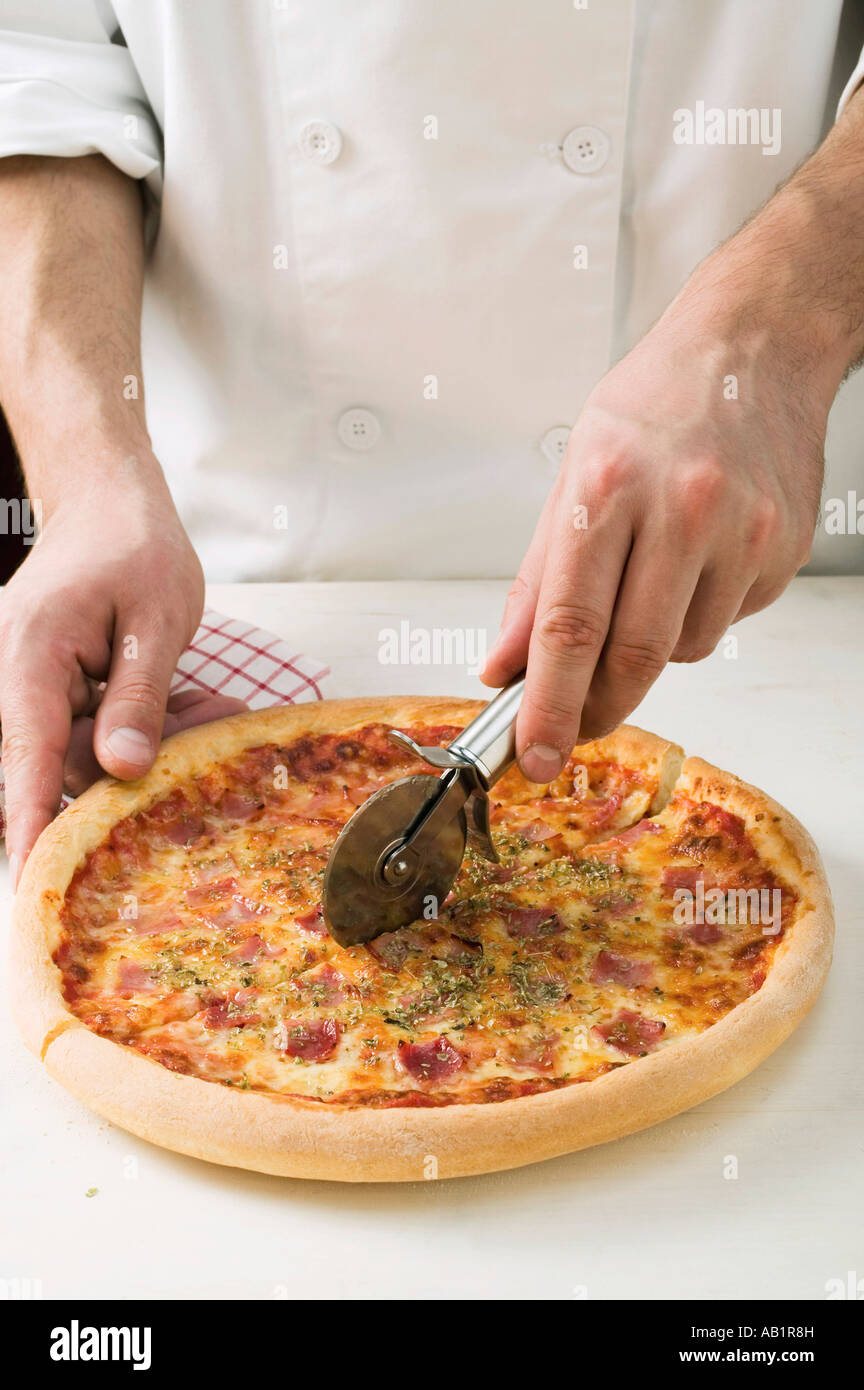 Halving an American style ham pizza FoodCollection Stock Photo - Alamy