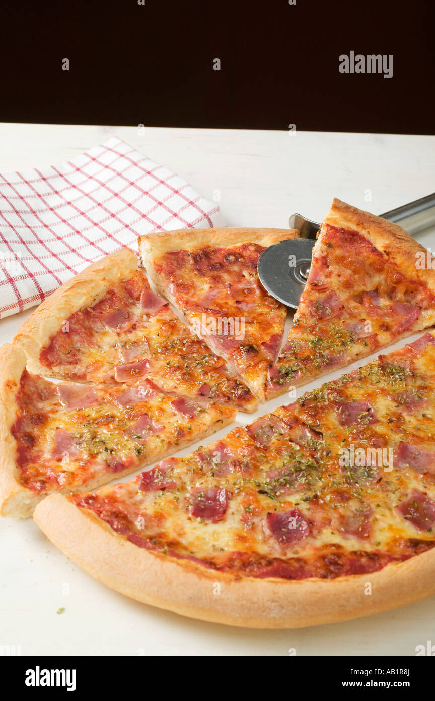 American style ham pizza cut into pieces FoodCollection Stock Photo - Alamy
