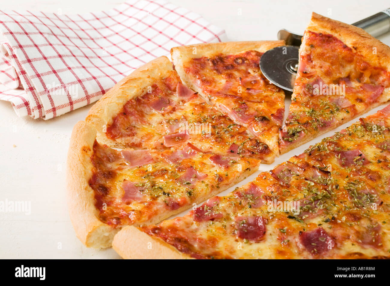 American style ham pizza cut into pieces FoodCollection Stock Photo - Alamy