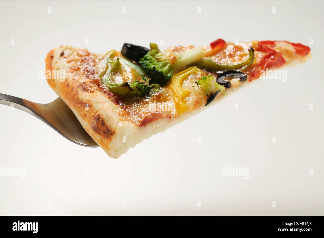 Slice of American style vegetable pizza on server FoodCollection Stock ...