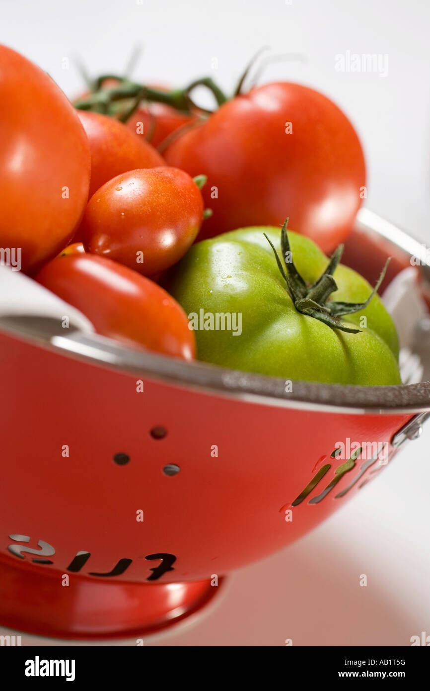 Various types of tomatoes in a colander FoodCollection Stock Photo - Alamy