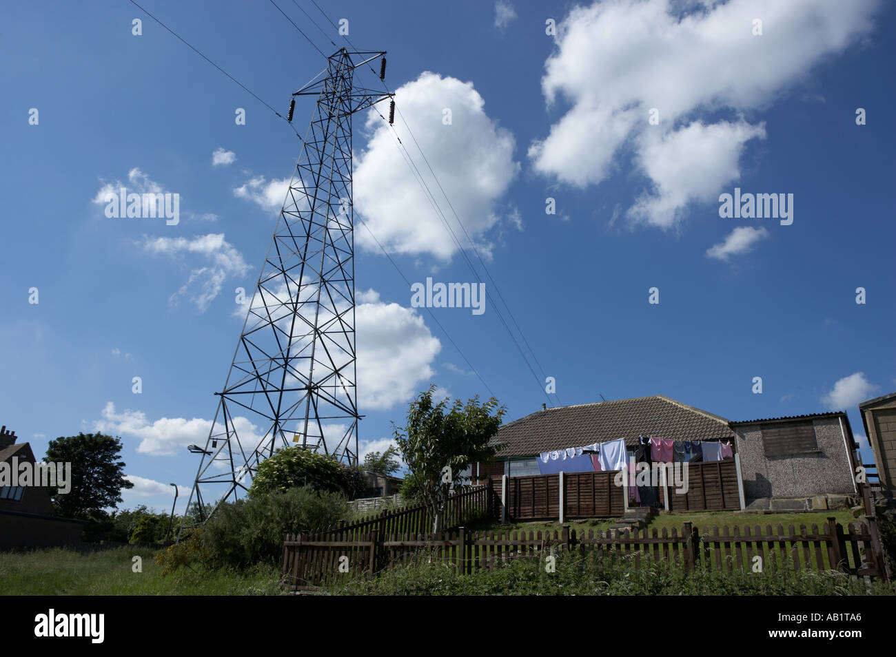 ELECTRICITY PYLON AND CABLES NEAR TO HOUSE Stock Photo - Alamy