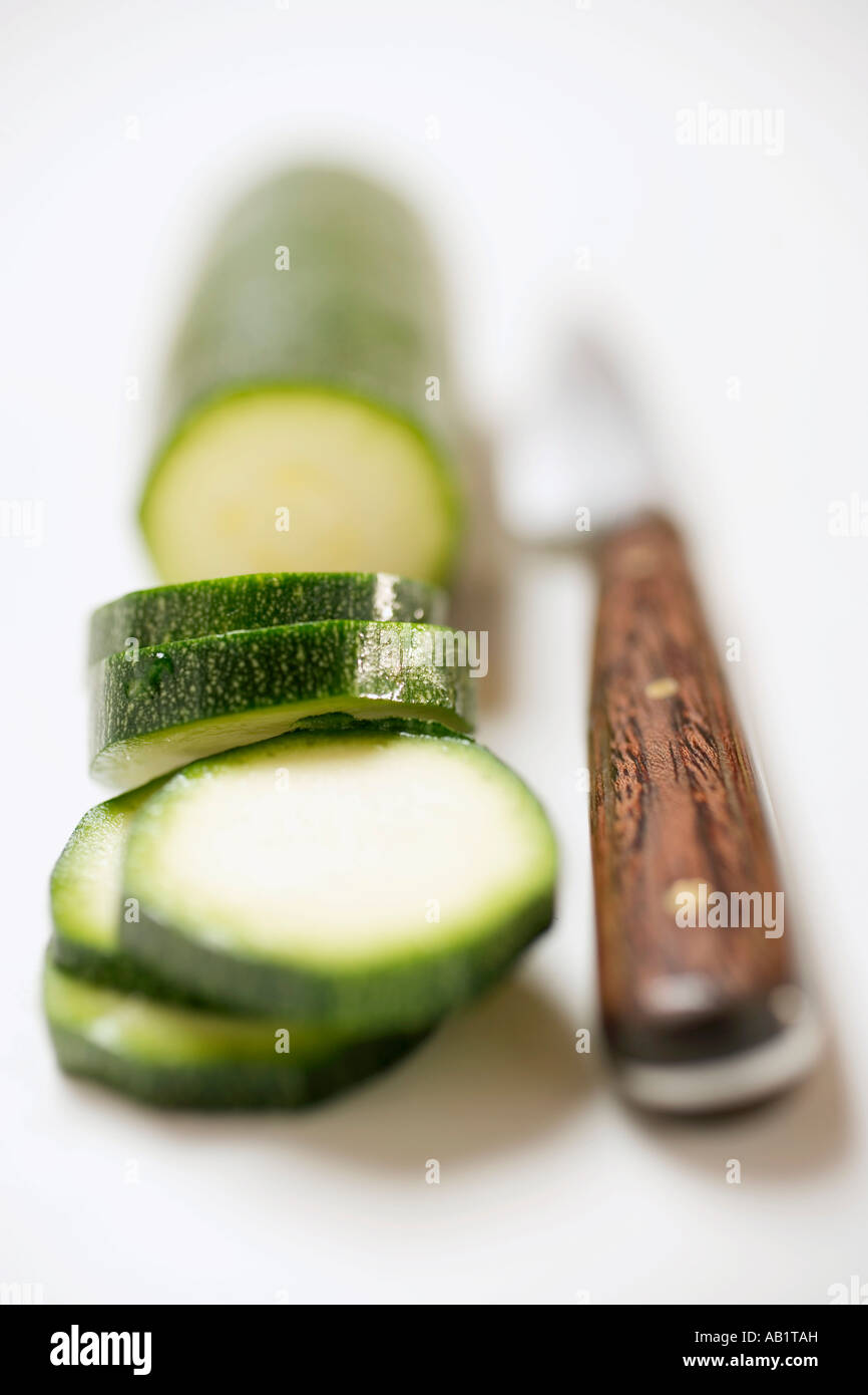 Courgette partly sliced with vegetable knife FoodCollection Stock Photo ...