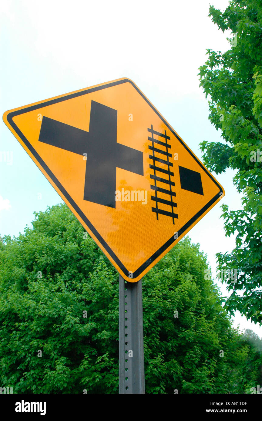 Train tracks and road intersection with both crossings marked on street ...