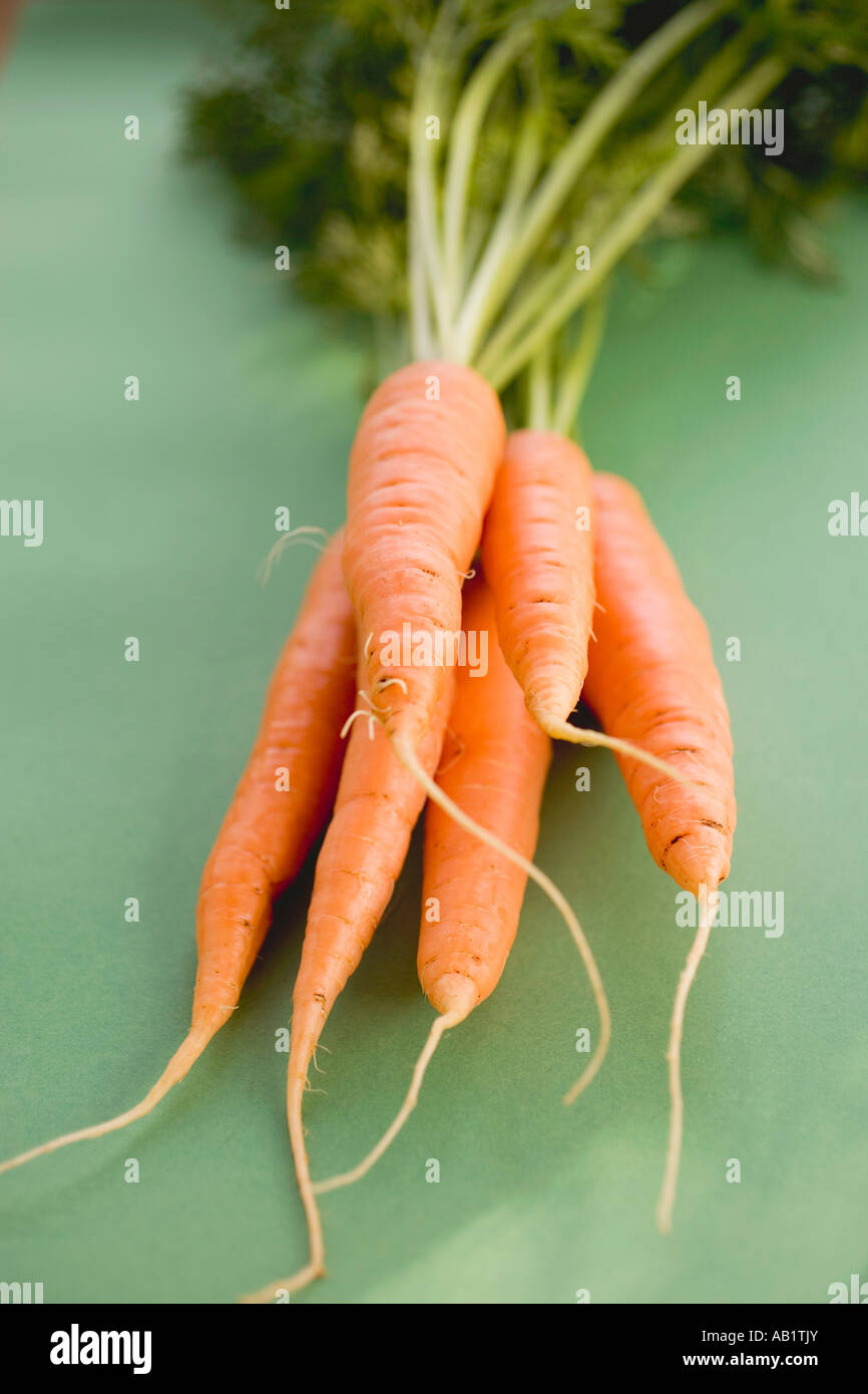 Fresh carrots on green background FoodCollection Stock Photo - Alamy