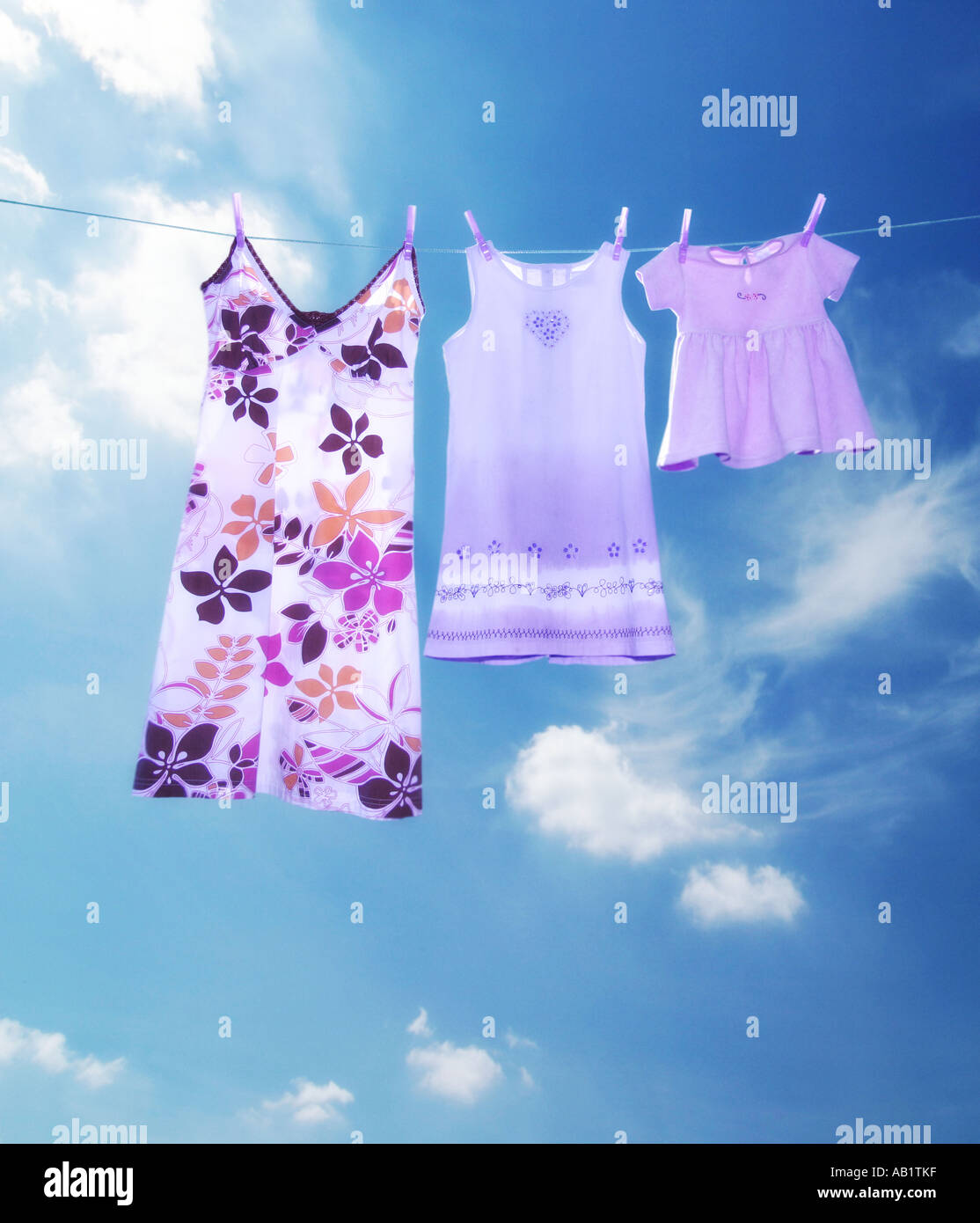 three dresses on a washing line Stock Photo - Alamy