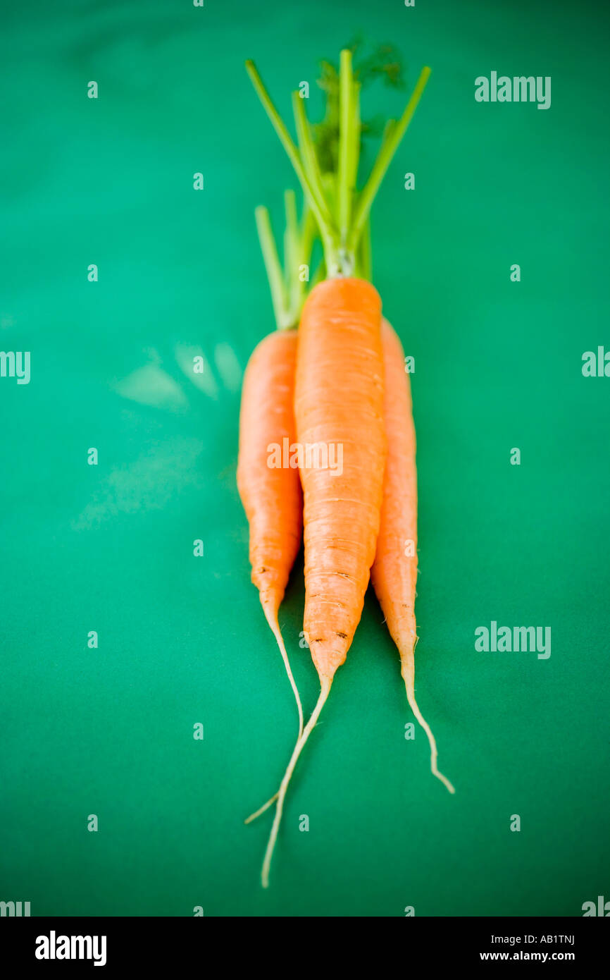 Fresh carrots on green background FoodCollection Stock Photo - Alamy