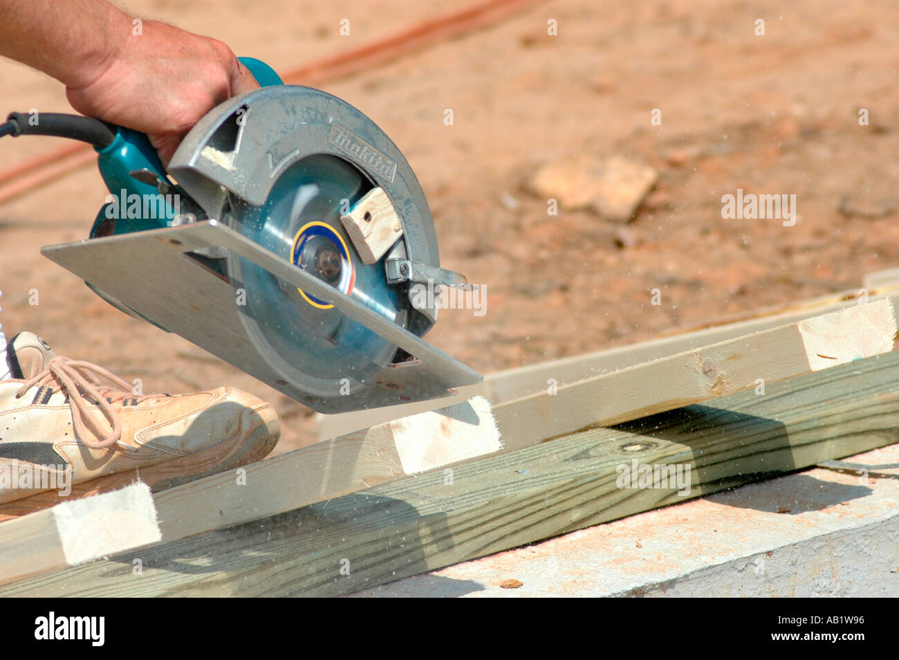 Measuring and cutting wood frame home construction by workers stick ...