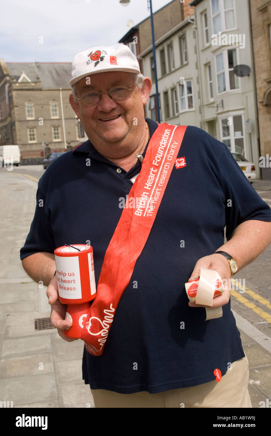 Man wearing baseball cap collecting in the street for British Heart ...