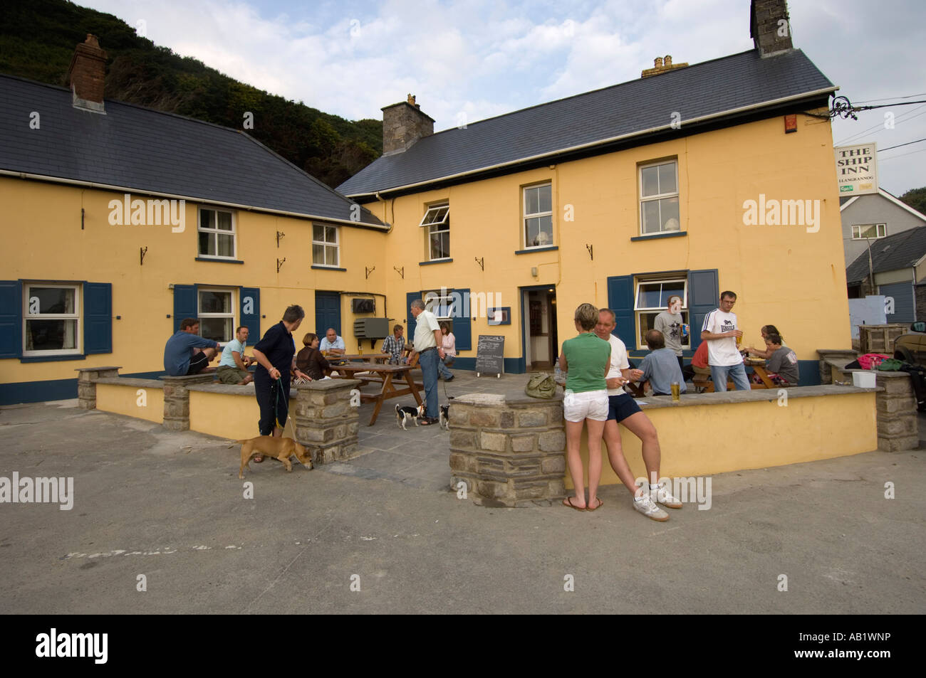 a Group of people drinking beer outside The Ship Inn Llangrannog ...