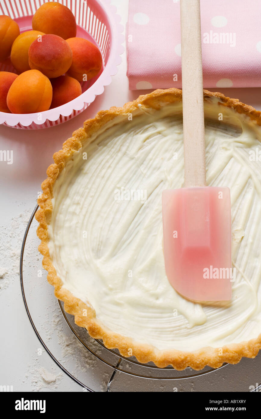Tart base spread with cream and fresh apricots FoodCollection Stock ...