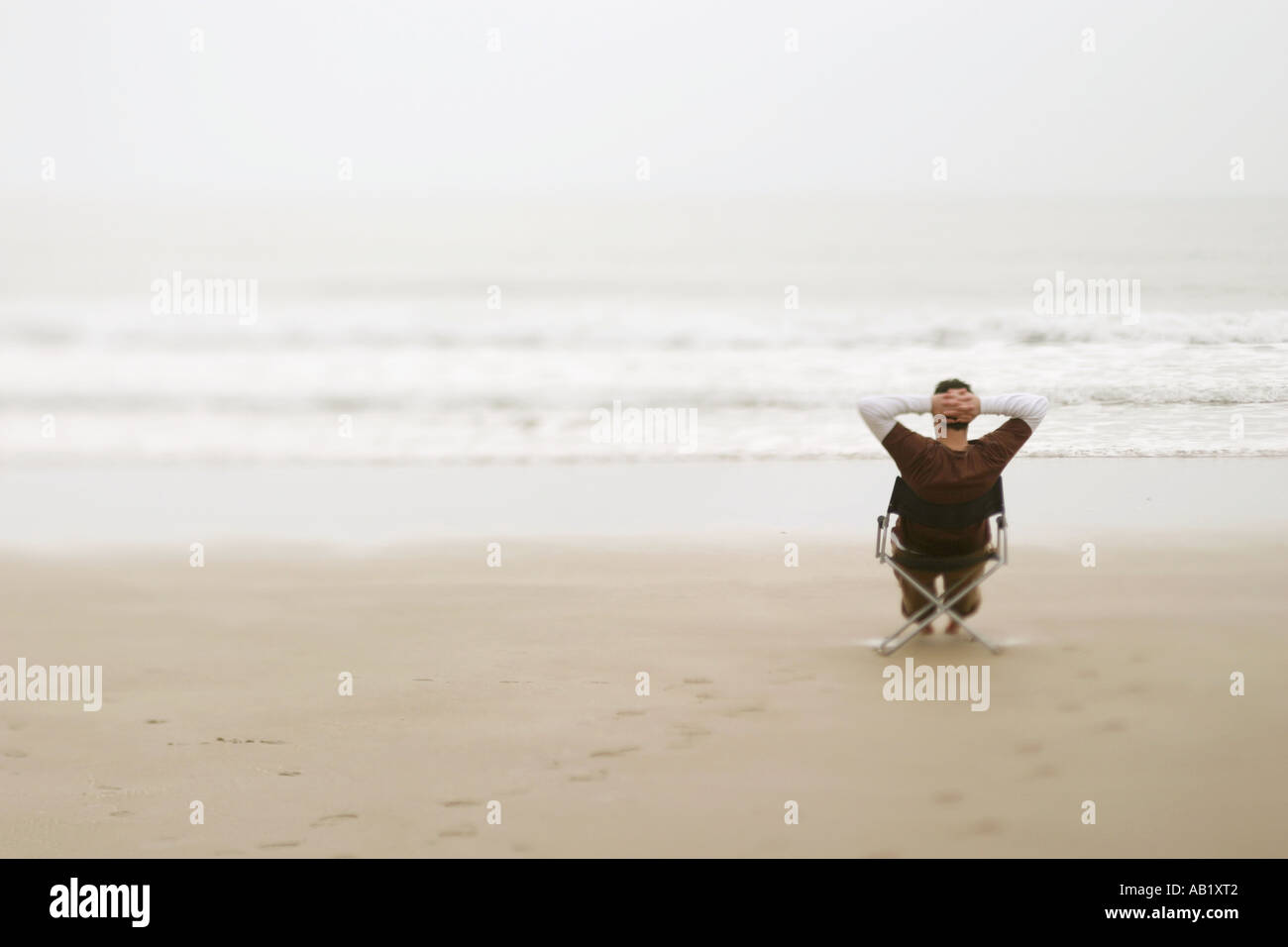a man relaxing in a chair by the sea Stock Photo - Alamy