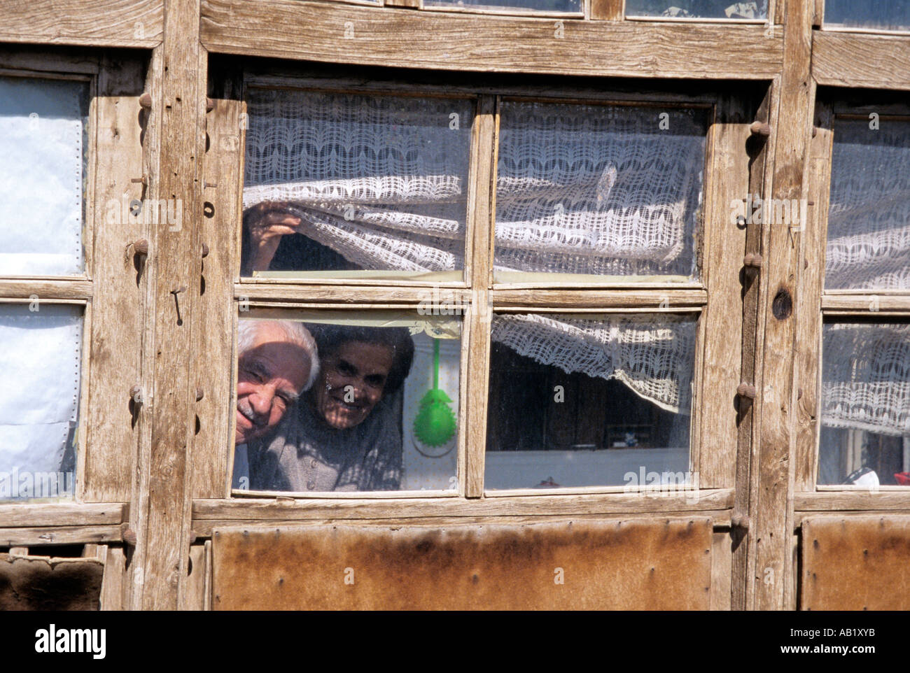 An Armenian family peek out of the window of their house in Esfehan ...