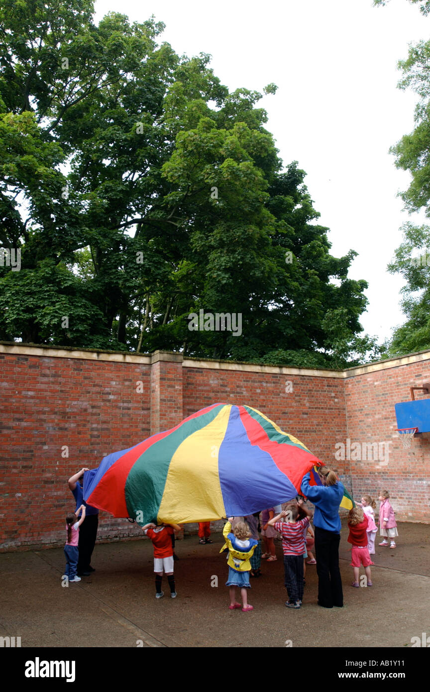 Group children play parachute game hi-res stock photography and images ...