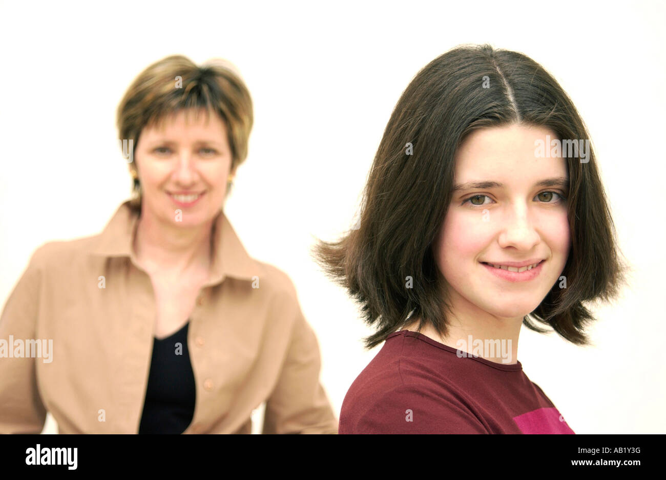 Mother standing behind her daughter Stock Photo - Alamy