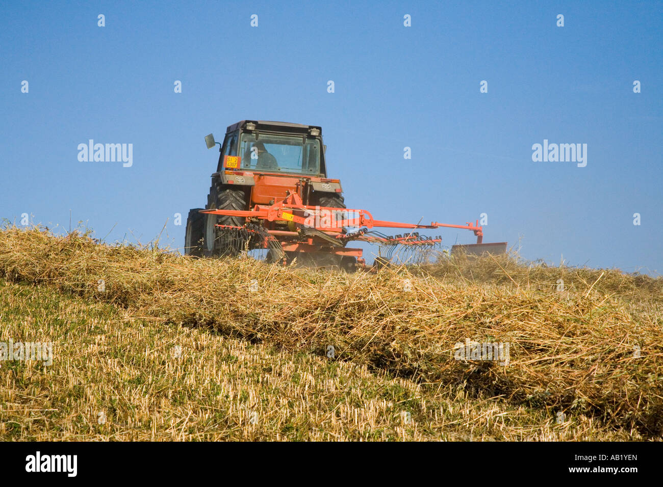 Italian summer Farming Landscape Farm Tractor turning hay Tuscany Italy ...