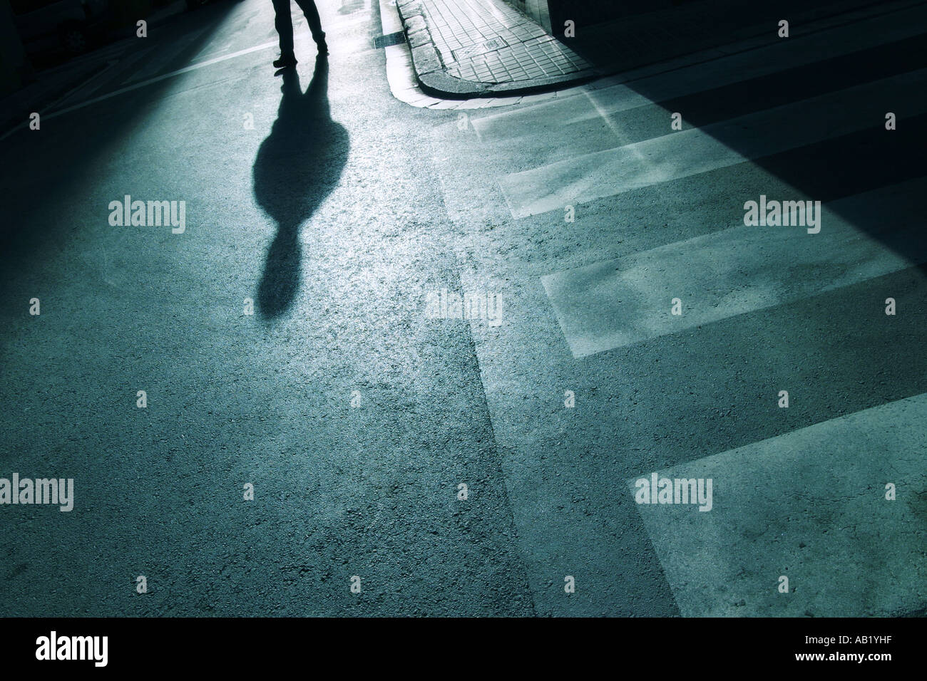 shadow of a person walking down the street Stock Photo - Alamy