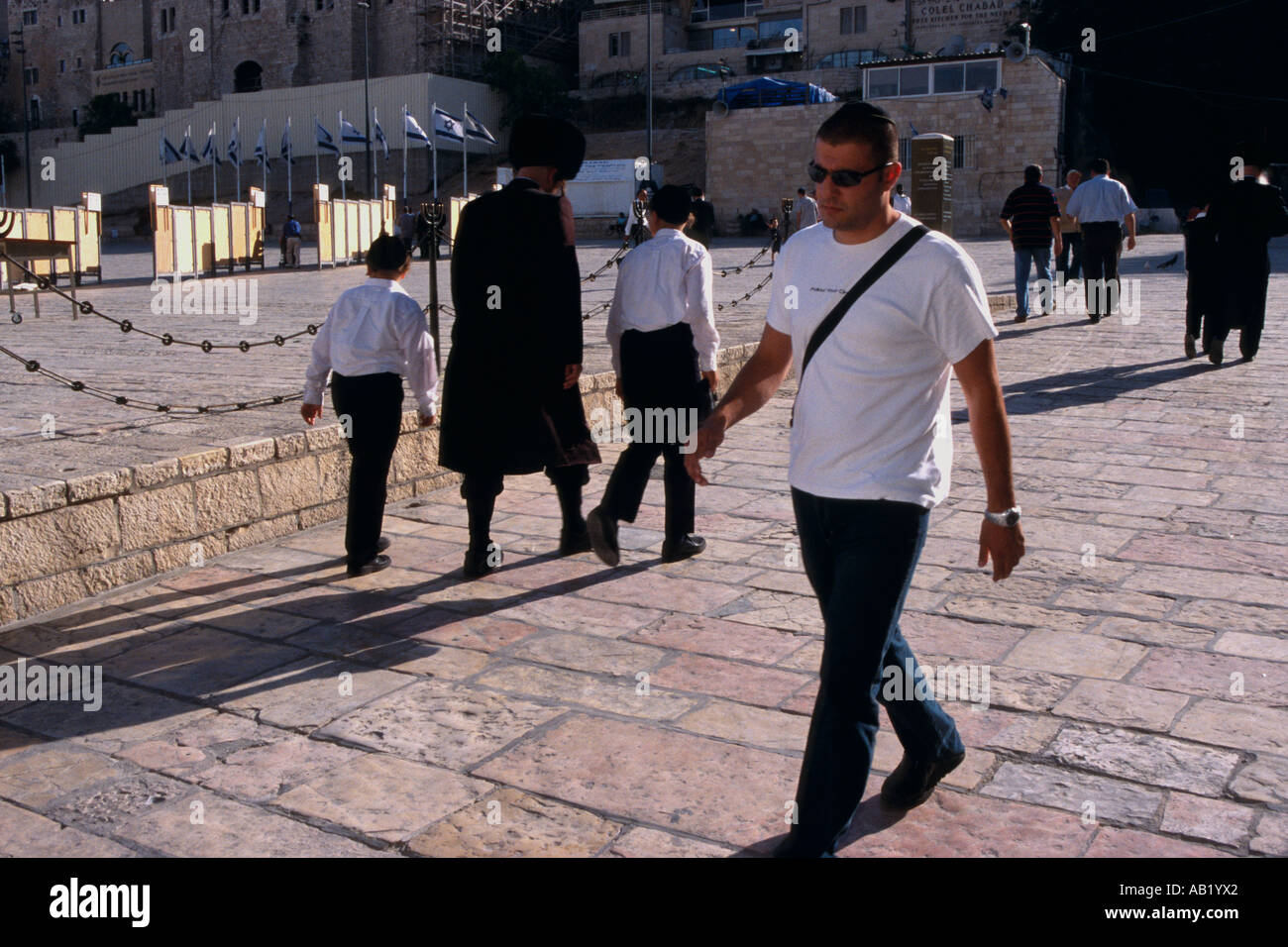People walk on the street beside the wailing wall Western Wall The ...