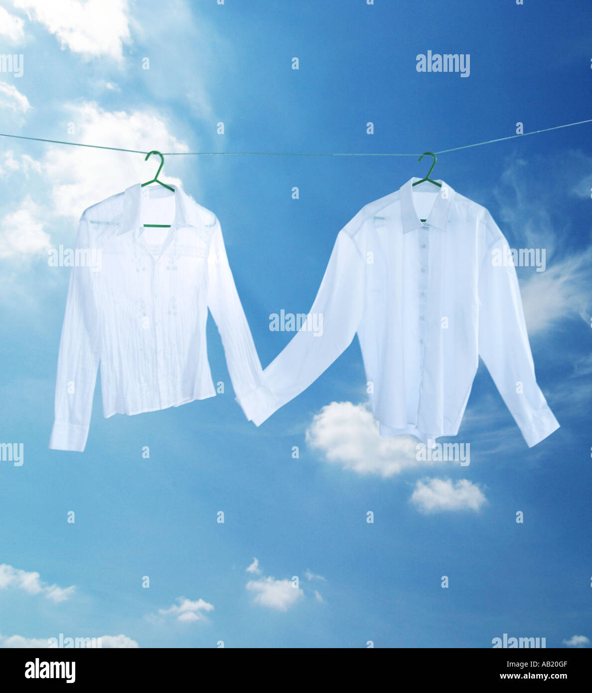 Shirts on washing line holding hands hi-res stock photography and ...