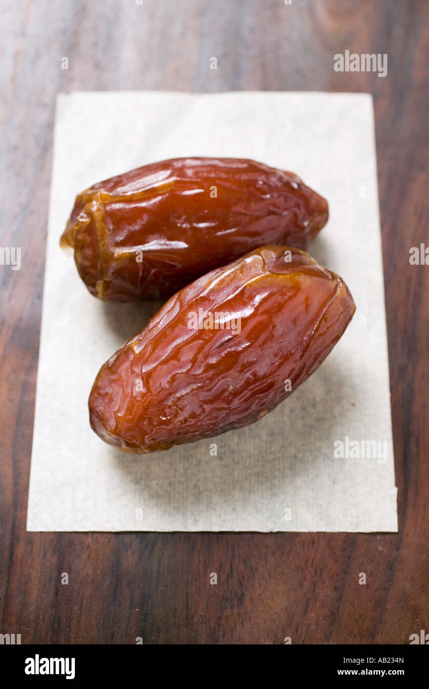 Two dried dates on paper FoodCollection Stock Photo - Alamy