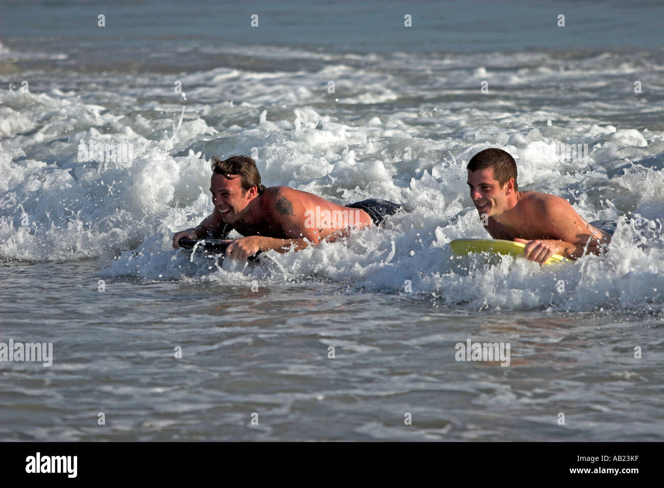 Two young men body boarding in surf Palolem south Goa India Stock Photo ...