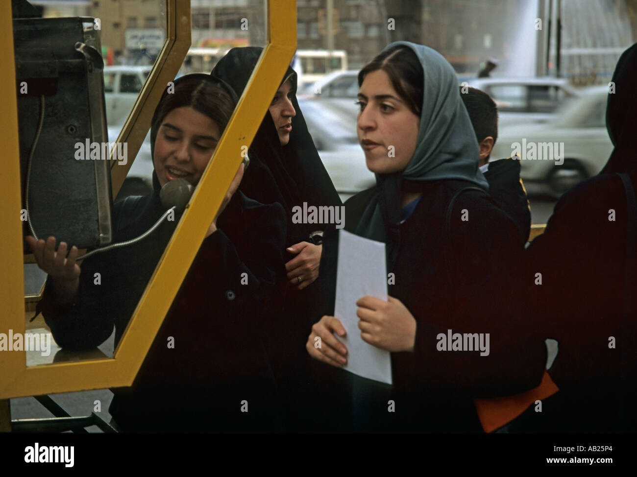 Young women in burqas at public phone booth, Tehran, Iran Stock Photo ...