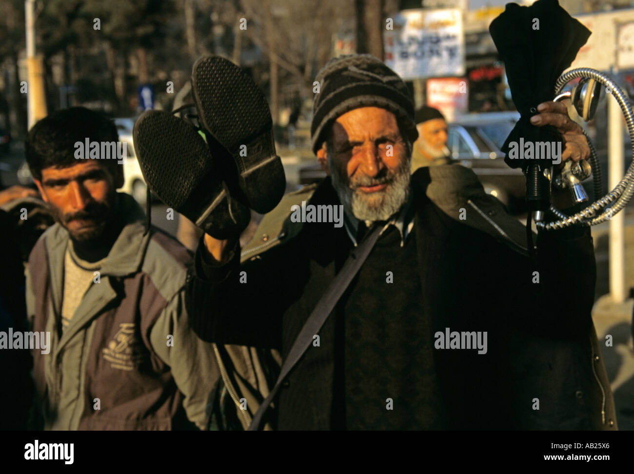 Armenian shoe repairman waving shoes, Tehran Iran Stock Photo - Alamy