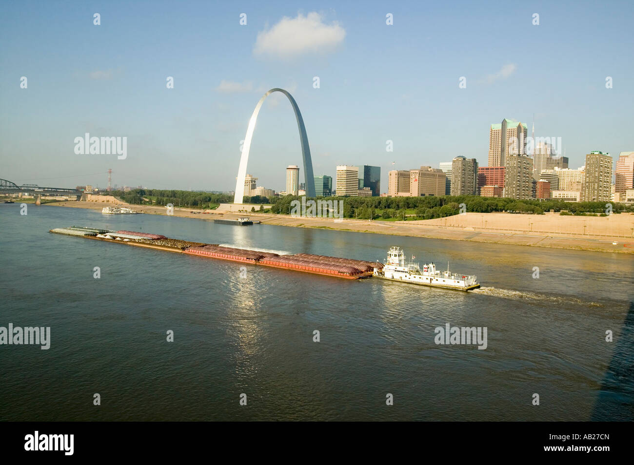 Daytime view of tug boat pushing barge down Mississippi River in front ...