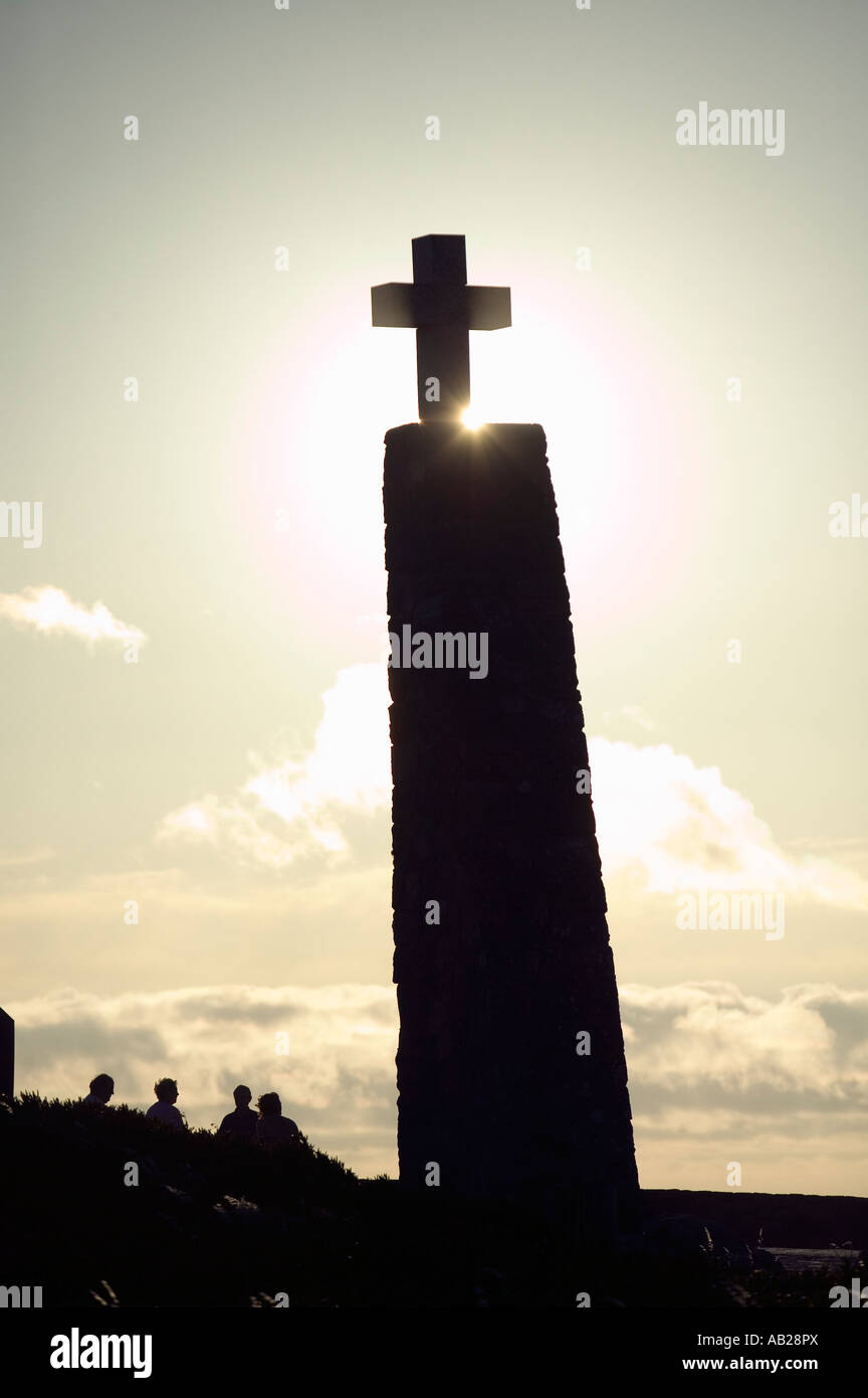 Cross with sun behind it at Cabo da Roca on the Atlantic Ocean in ...