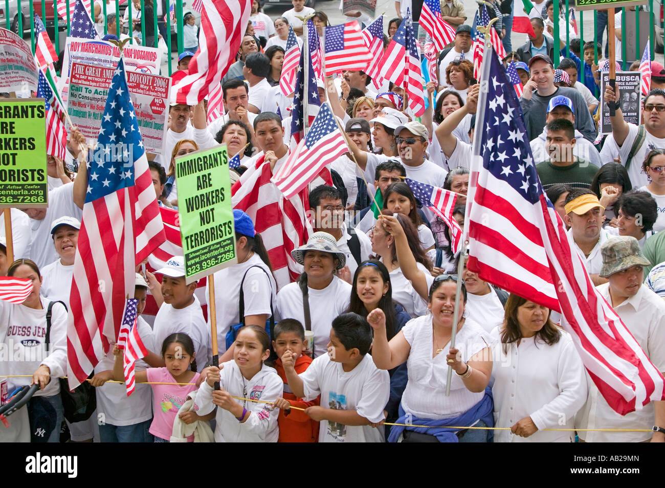 Hispanics wave American flags as hundreds of thousands of immigrants ...