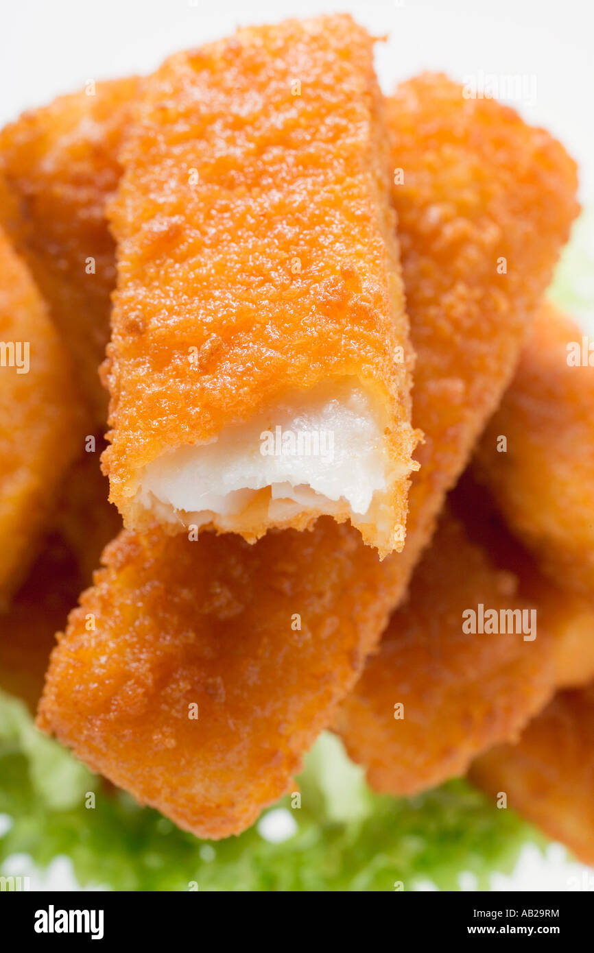 Fish finger with a bite taken on a heap of fish fingers FoodCollection ...