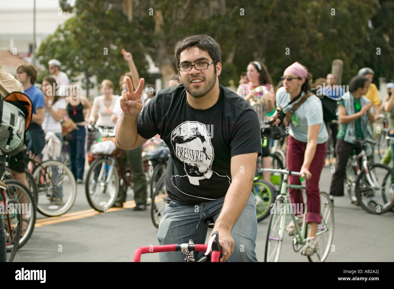 Protesters arrive on bicycle and give the peace sign at an anti Iraq ...