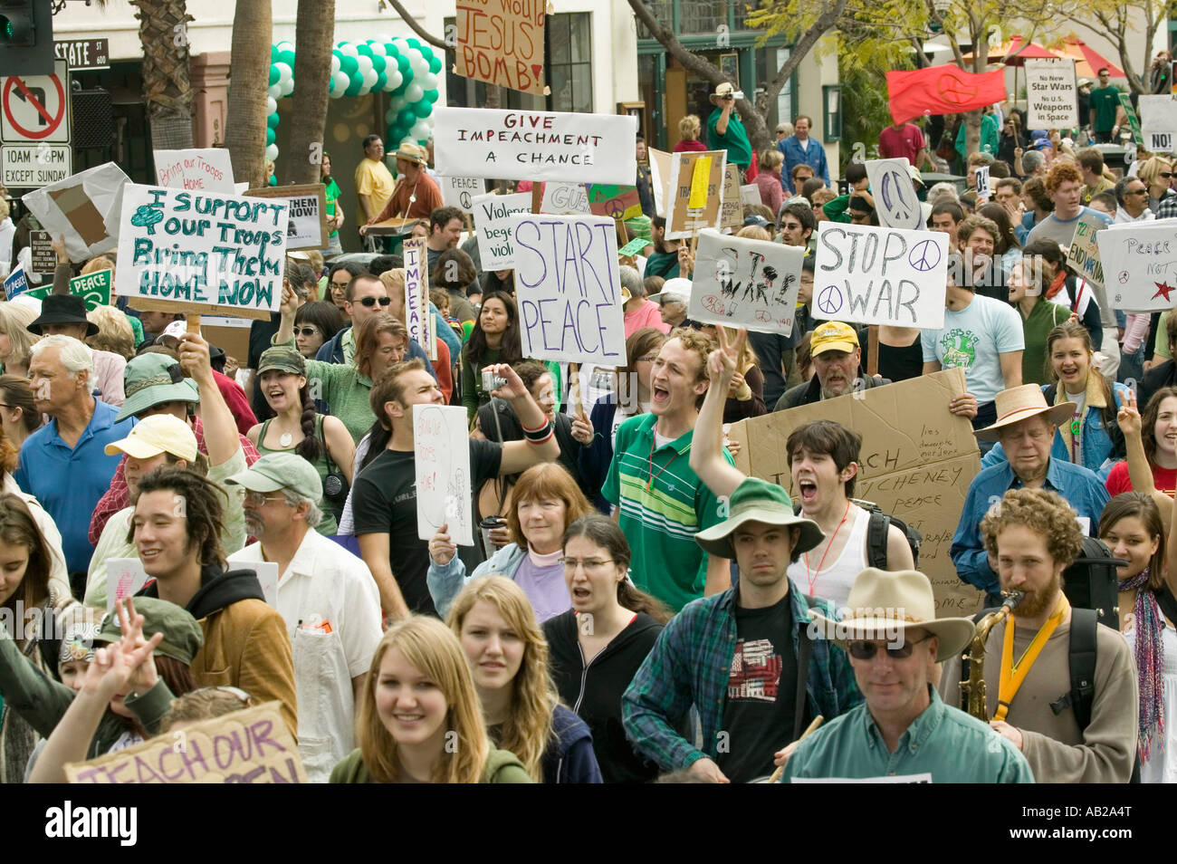 A large crowd of protesters march and chant down State Street carrying ...