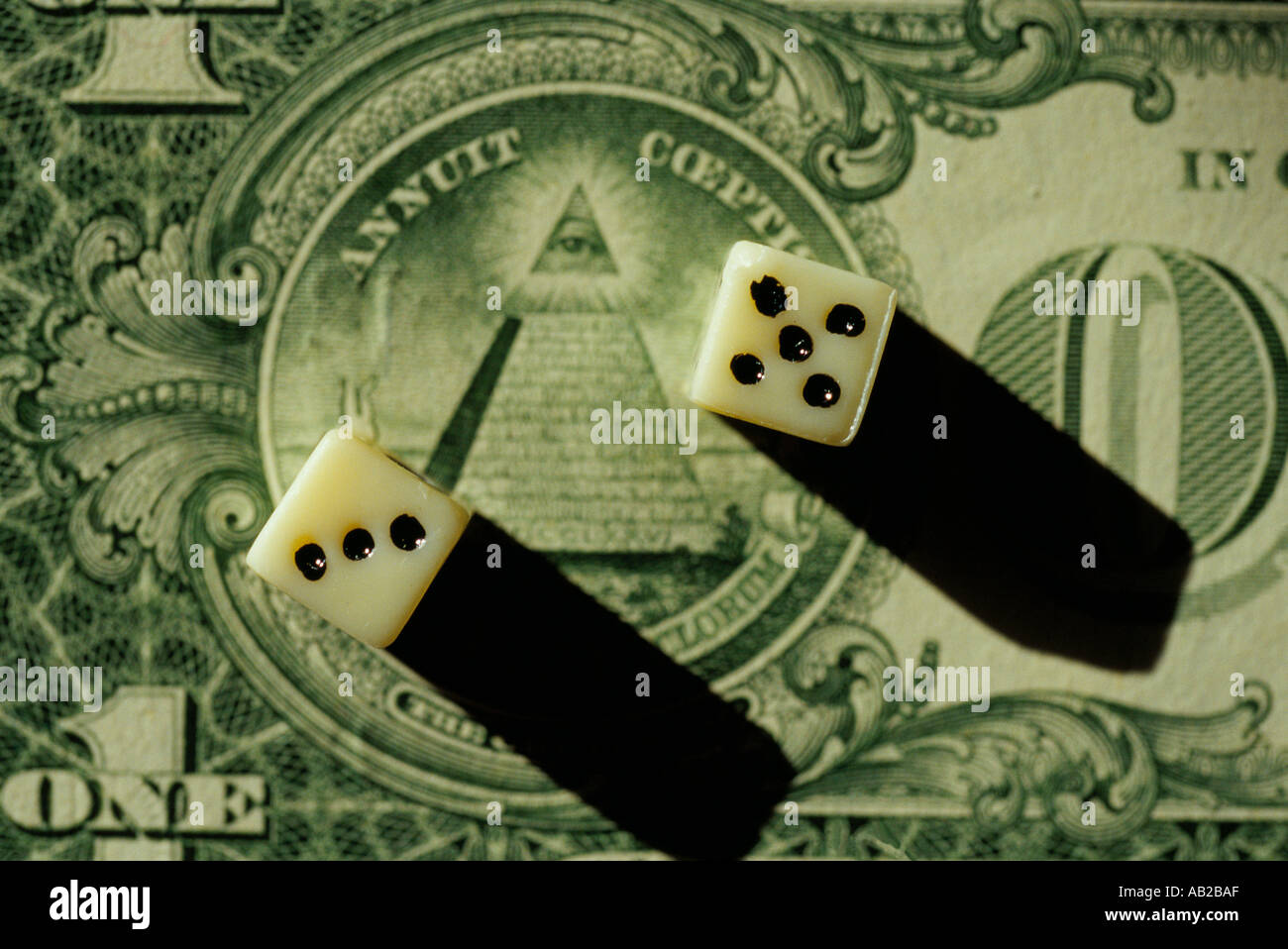A pair of dice lie on the backside of a one dollar bill Stock Photo - Alamy