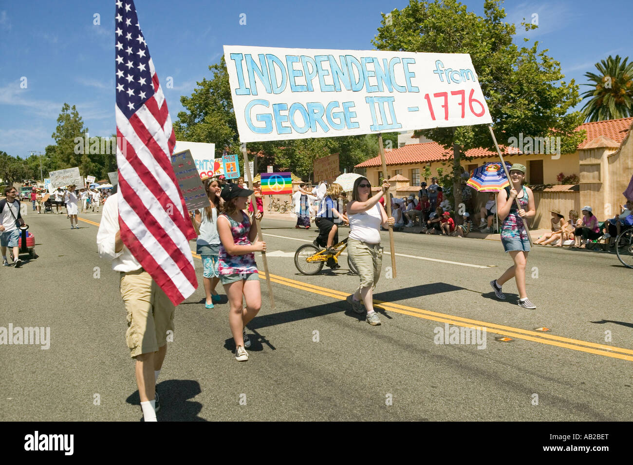 Parade participants carrying banner protesting George W Bush make their ...