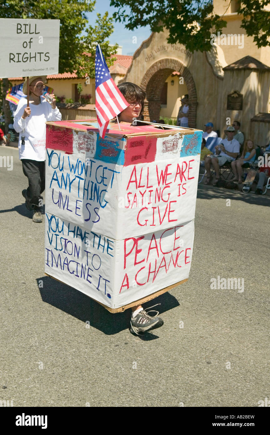 Parade participants carrying signs about peace make their way down main ...