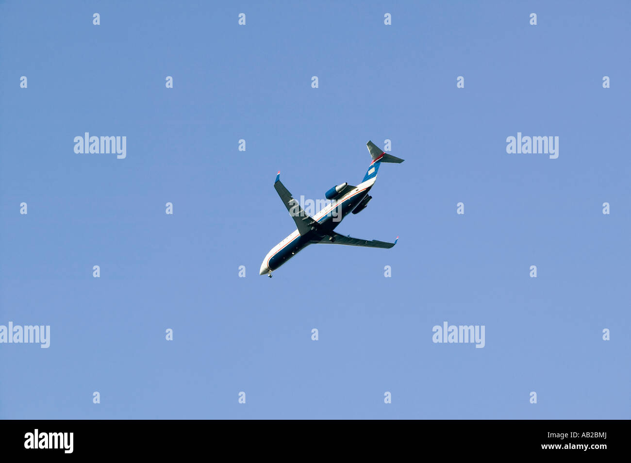 Commercial jet airplane flies overhead in a clear blue sky Stock Photo ...