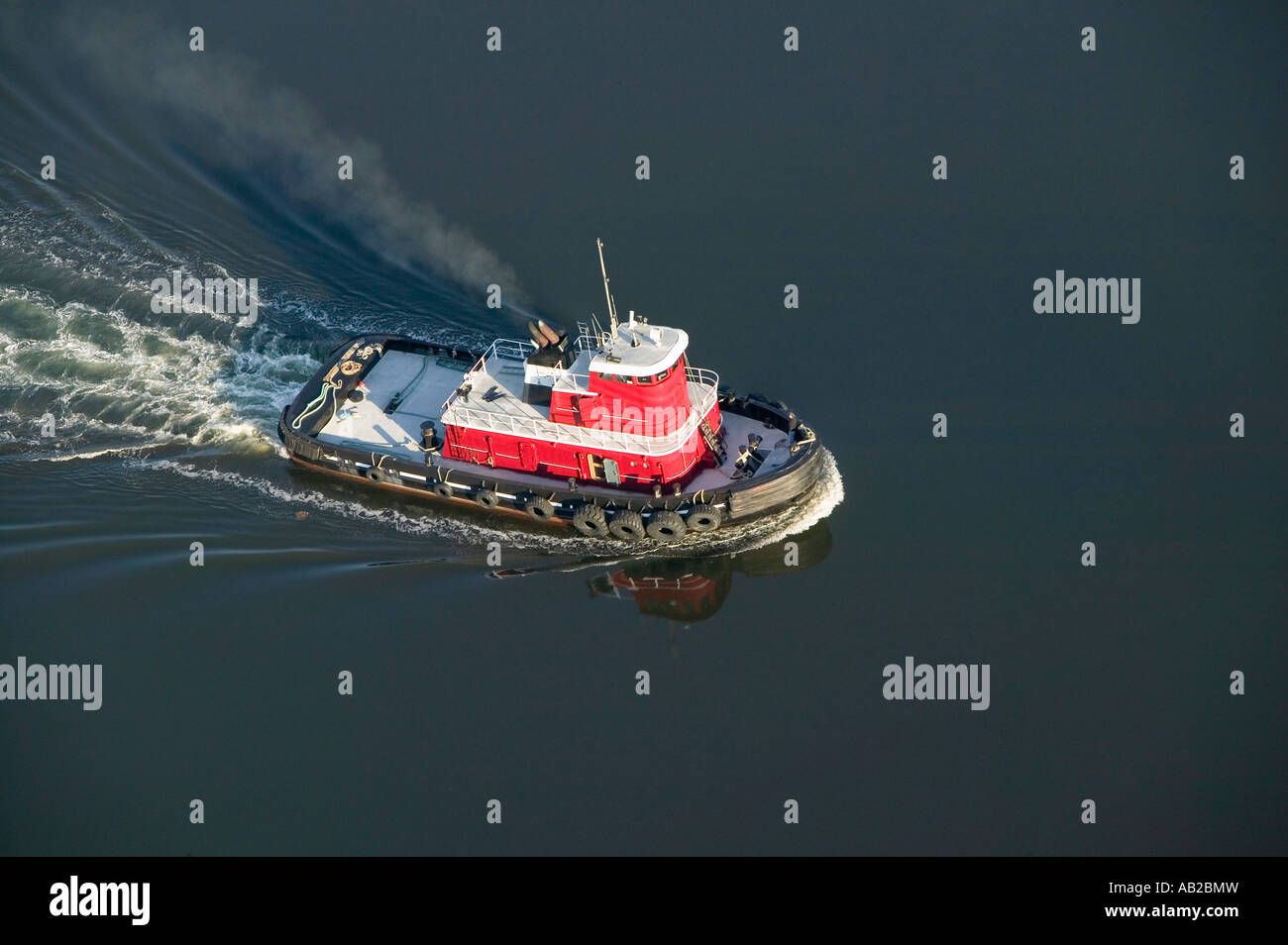 A aerial view of a bright red tug boat outside of Portland Maine Stock ...