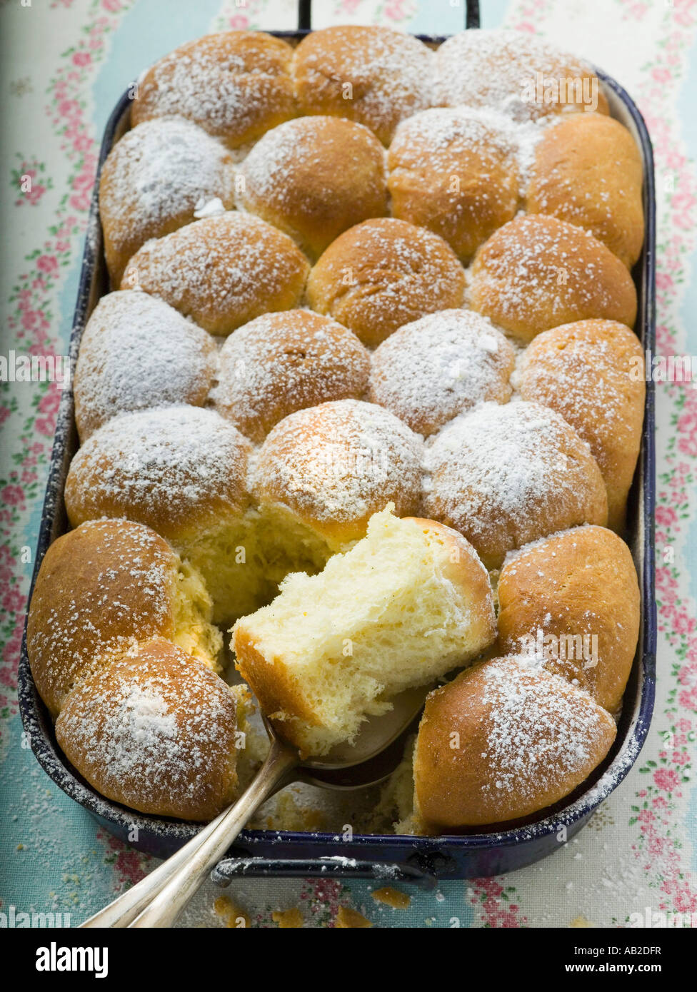 Buchteln sweet yeast rolls with icing sugar in baking tin ...