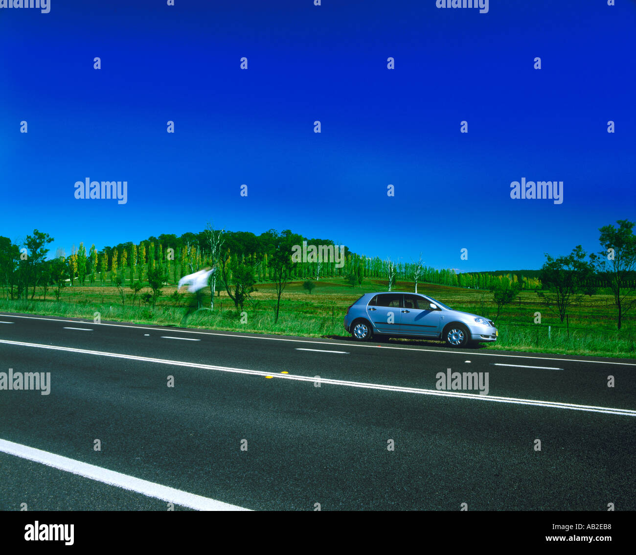 Man running to his car at highway Stock Photo - Alamy