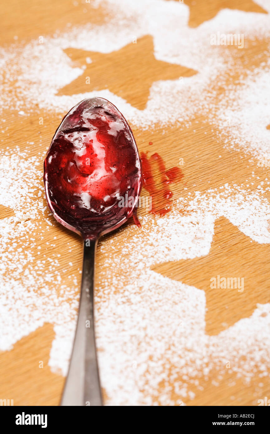 Star shapes outlined in icing sugar and spoon with jam FoodCollection ...