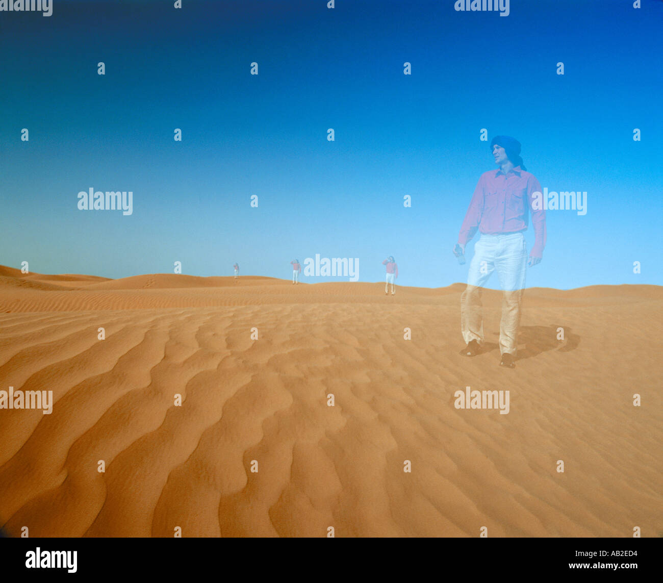 Man in a desert and his transparent images in a distance Stock Photo ...