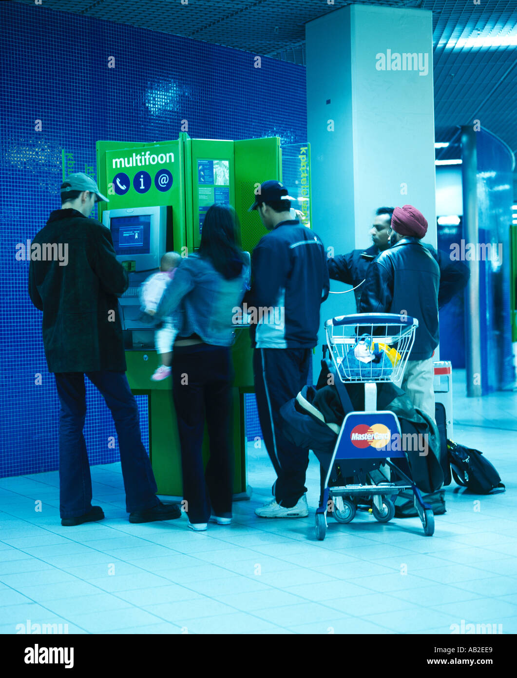 Group of people at telephone booth in airport Stock Photo - Alamy